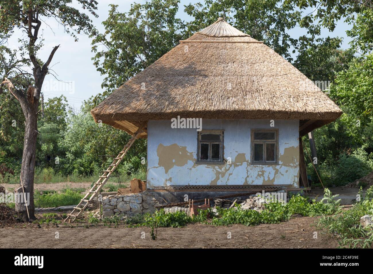 Traditional moldovian rural house. House is under roofing from bulrush ...
