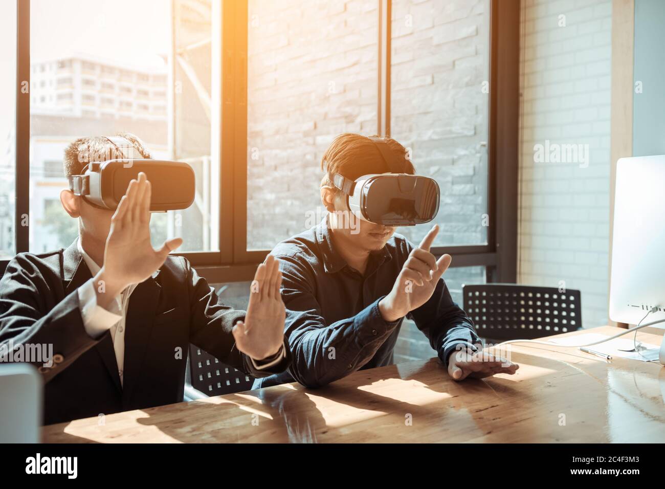 Two business business persons with virtual reality headsets in the ...