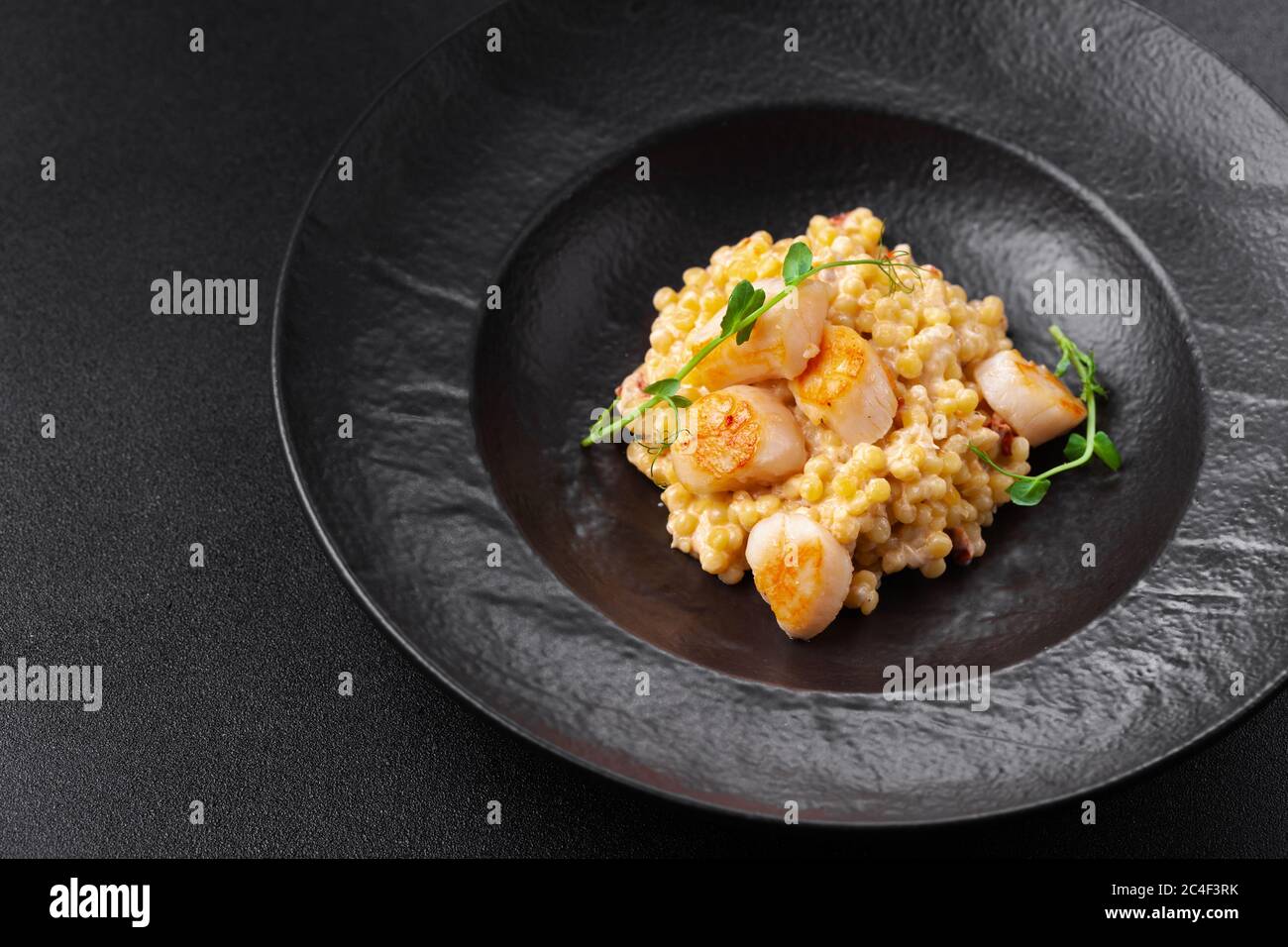 Ptitim, birdy pasta, couscous with fried scallops, herbs Stock Photo ...