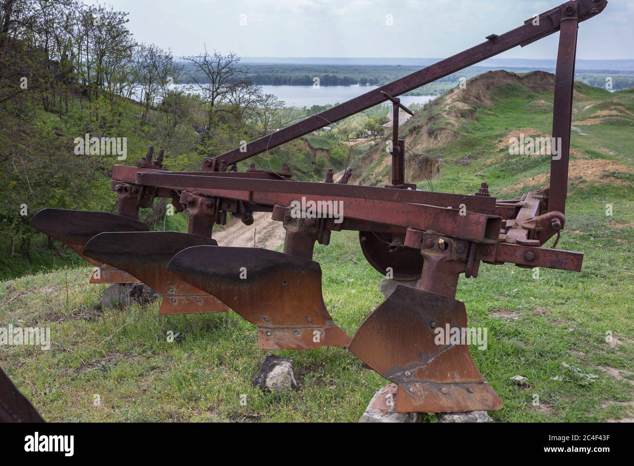 Old rusty plow. This plow is located on top of a hill. Behind the plow ...