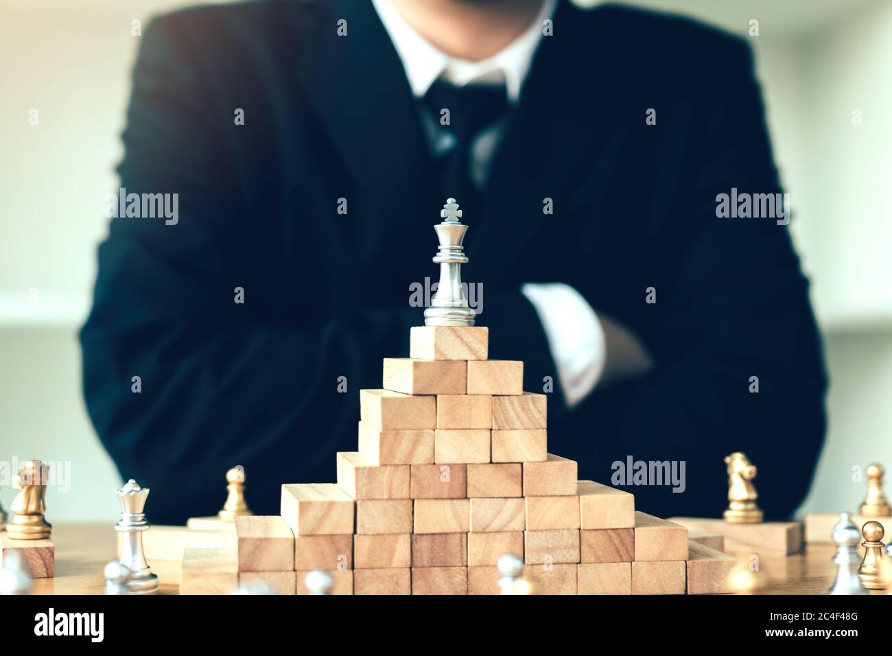 Leadership concept with businessman looking chess on top wooden block ...