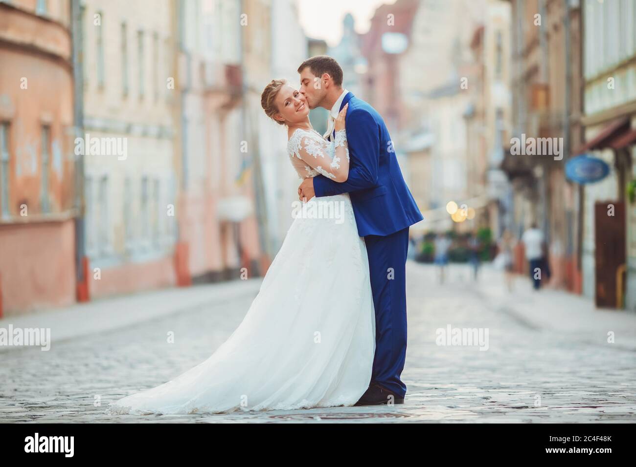 bride and groom walk around the old town Stock Photo - Alamy