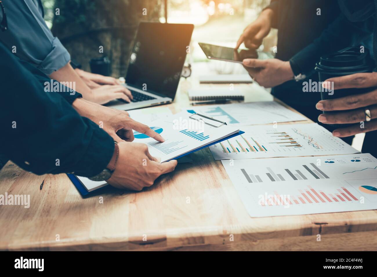 Teamwork with business people analysis cost graph on desk at meeting ...