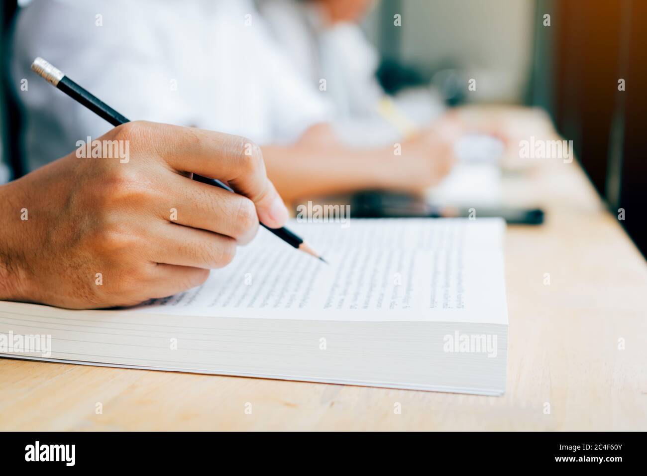 Group of students are writing a university test Stock Photo - Alamy