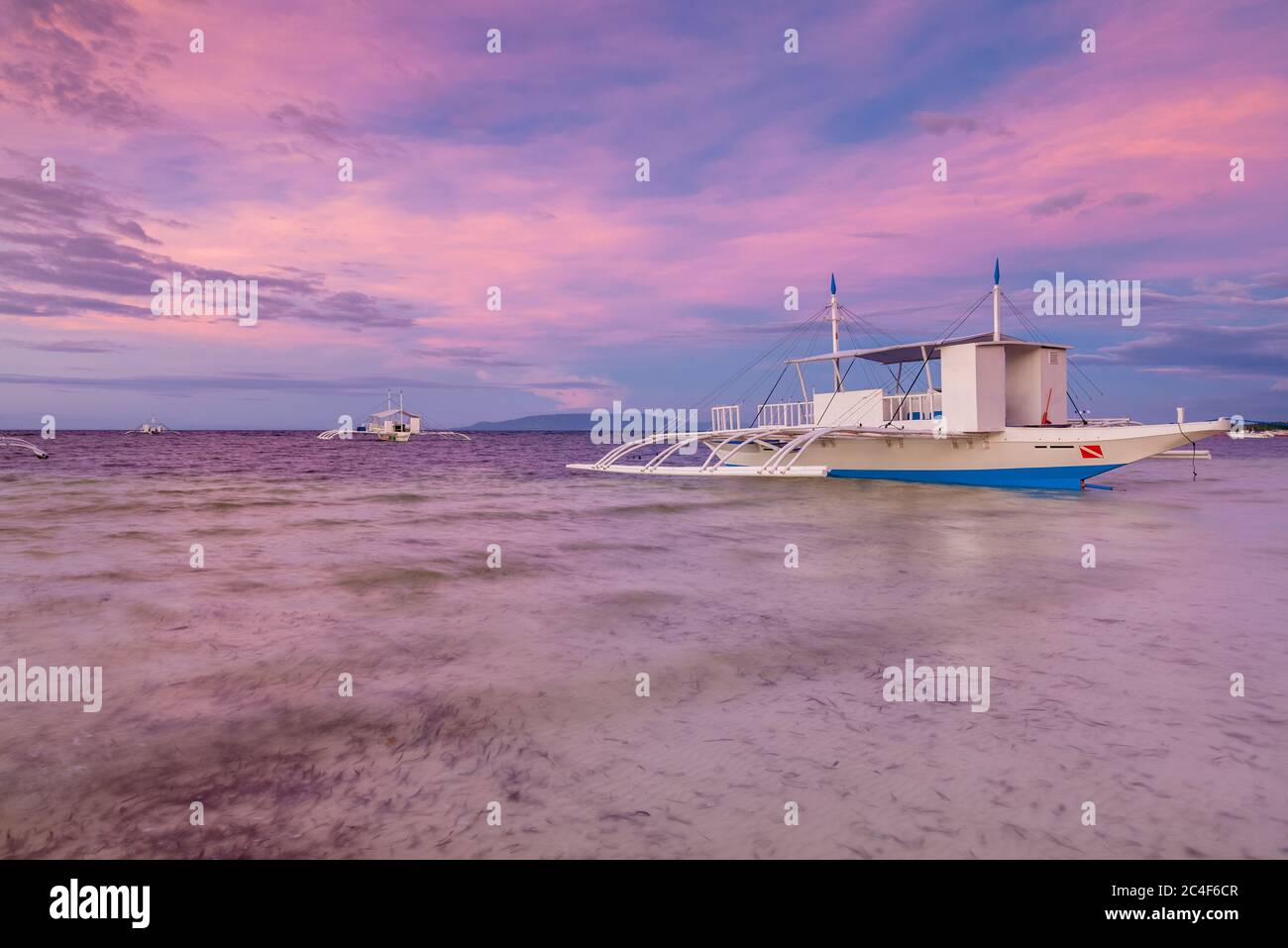 Traditional Filipino Bangka boats on a beach at sunset, Panglao ...