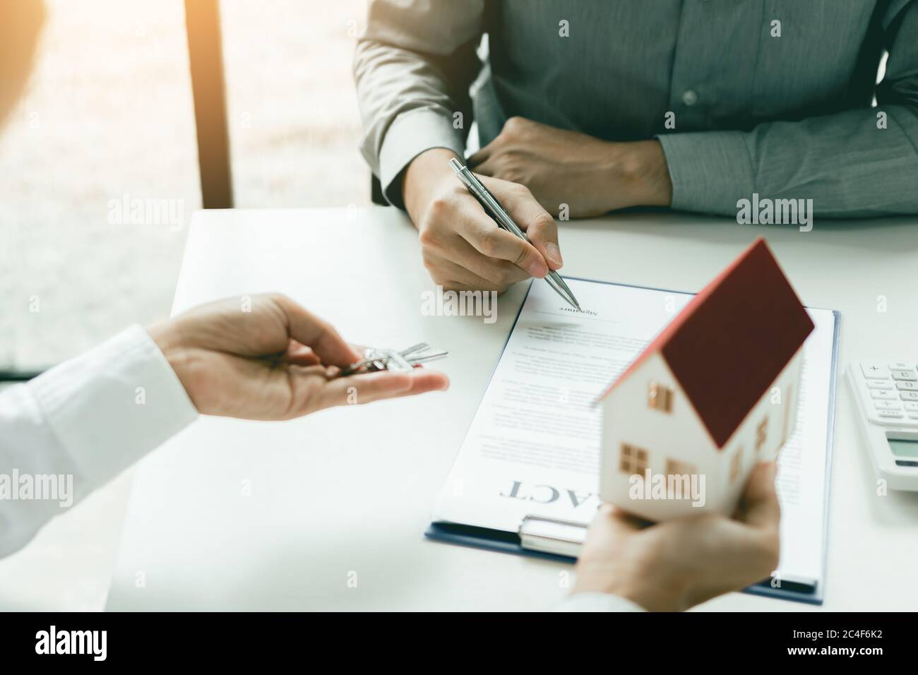Customer writing signing signature on paper contract with real estate ...