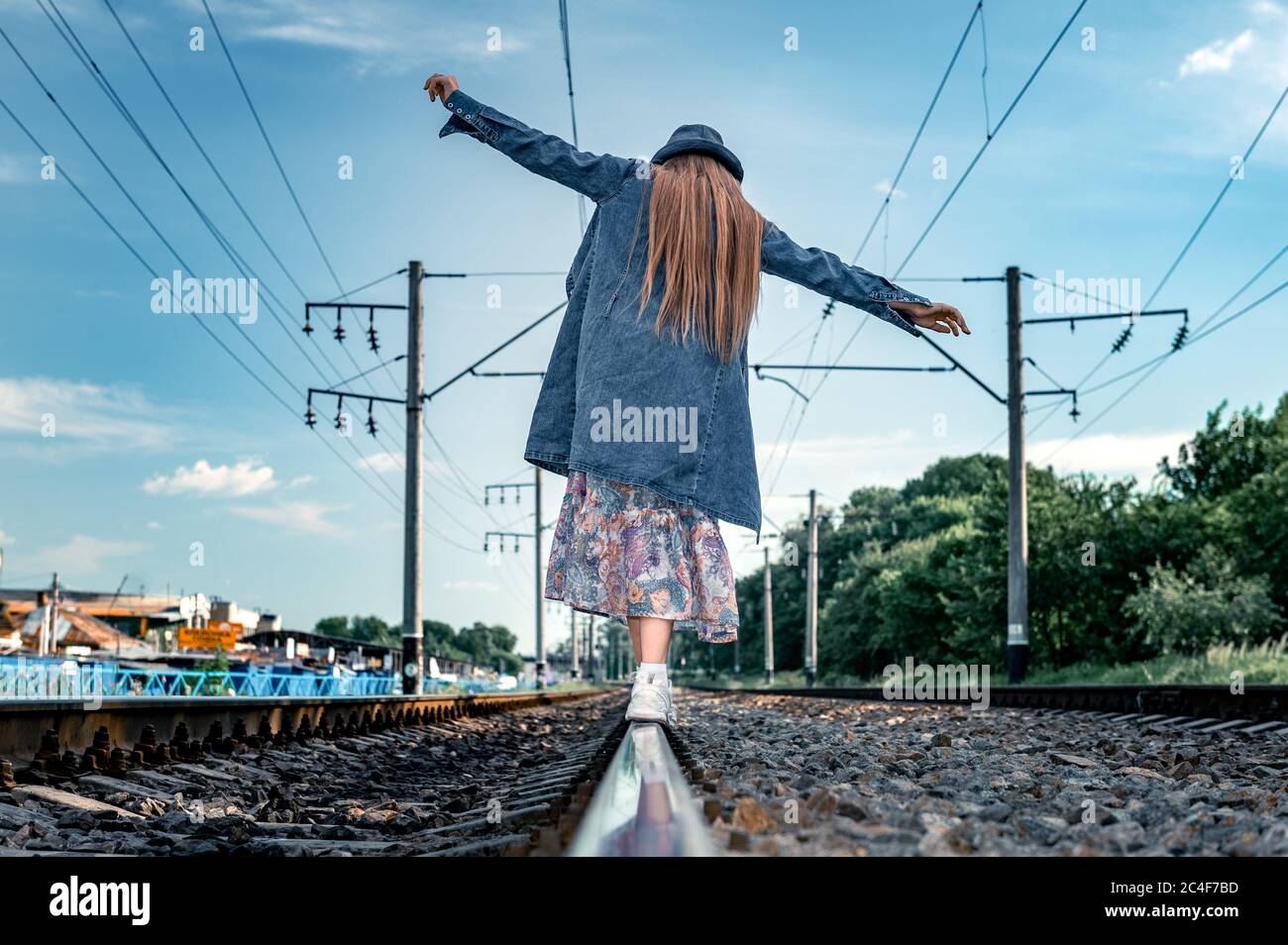 Teen girl walks by rail. Girl is walking around the rails Stock Photo ...