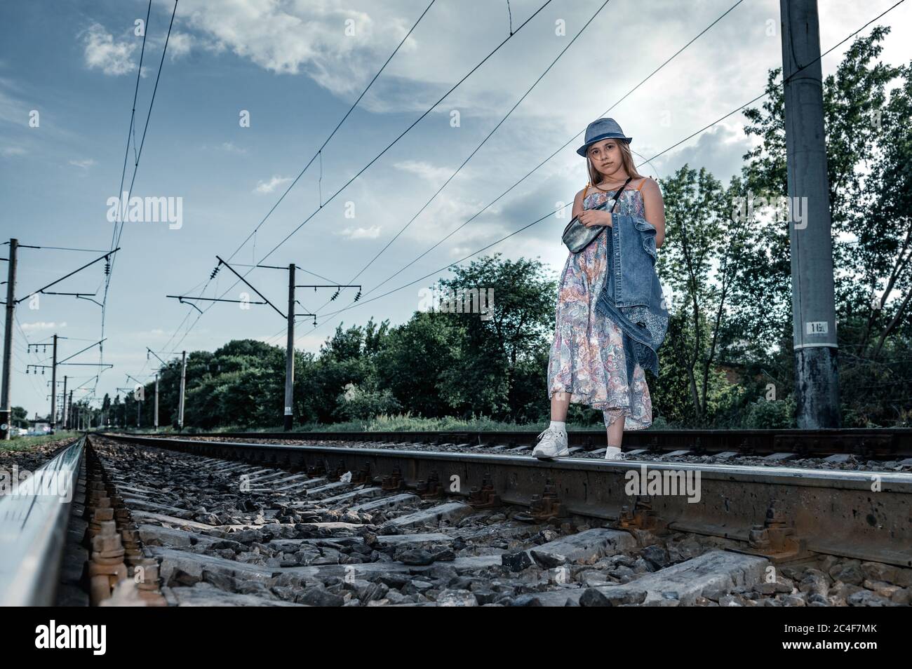 Teen girl walks by rail. Girl is walking around the rails Stock Photo ...