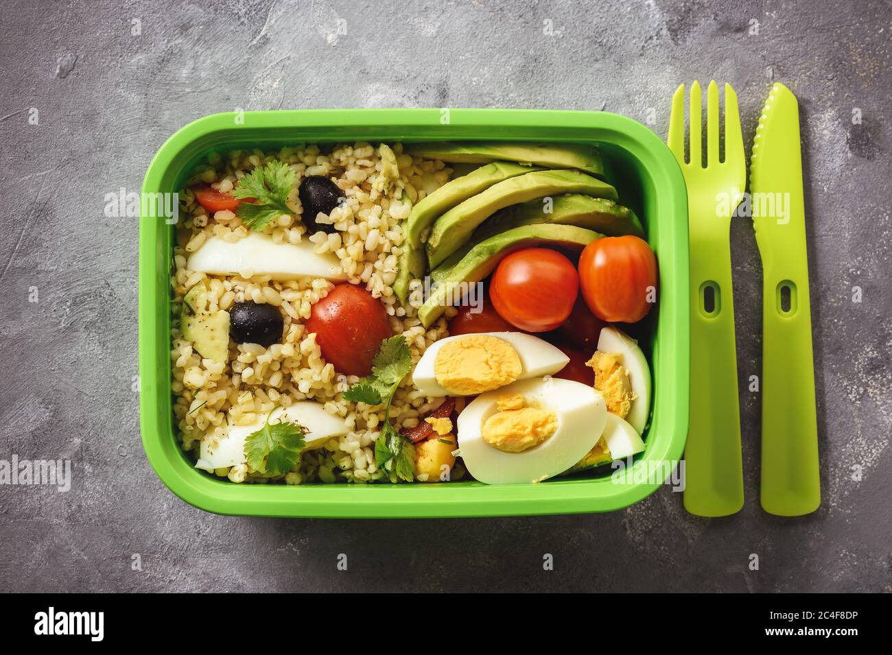Lunch box with bulgur, avocado, eggs and tomatoes Stock Photo - Alamy