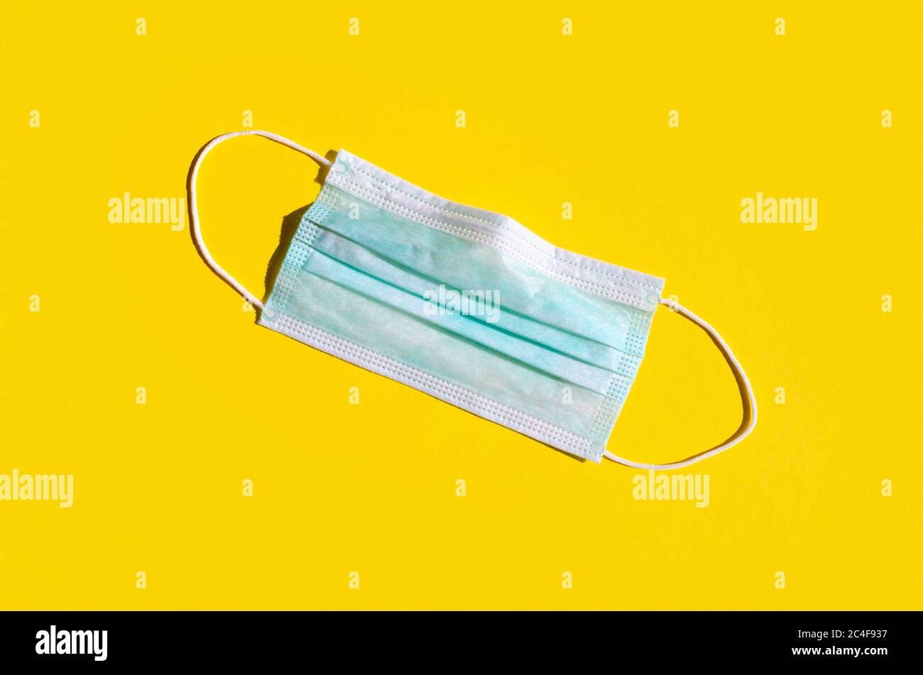 Medical or surgical face mask on a bright yellow background Stock Photo ...