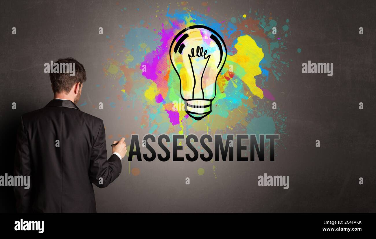 businessman drawing colorful light bulb with ASSESSMENT inscription on ...