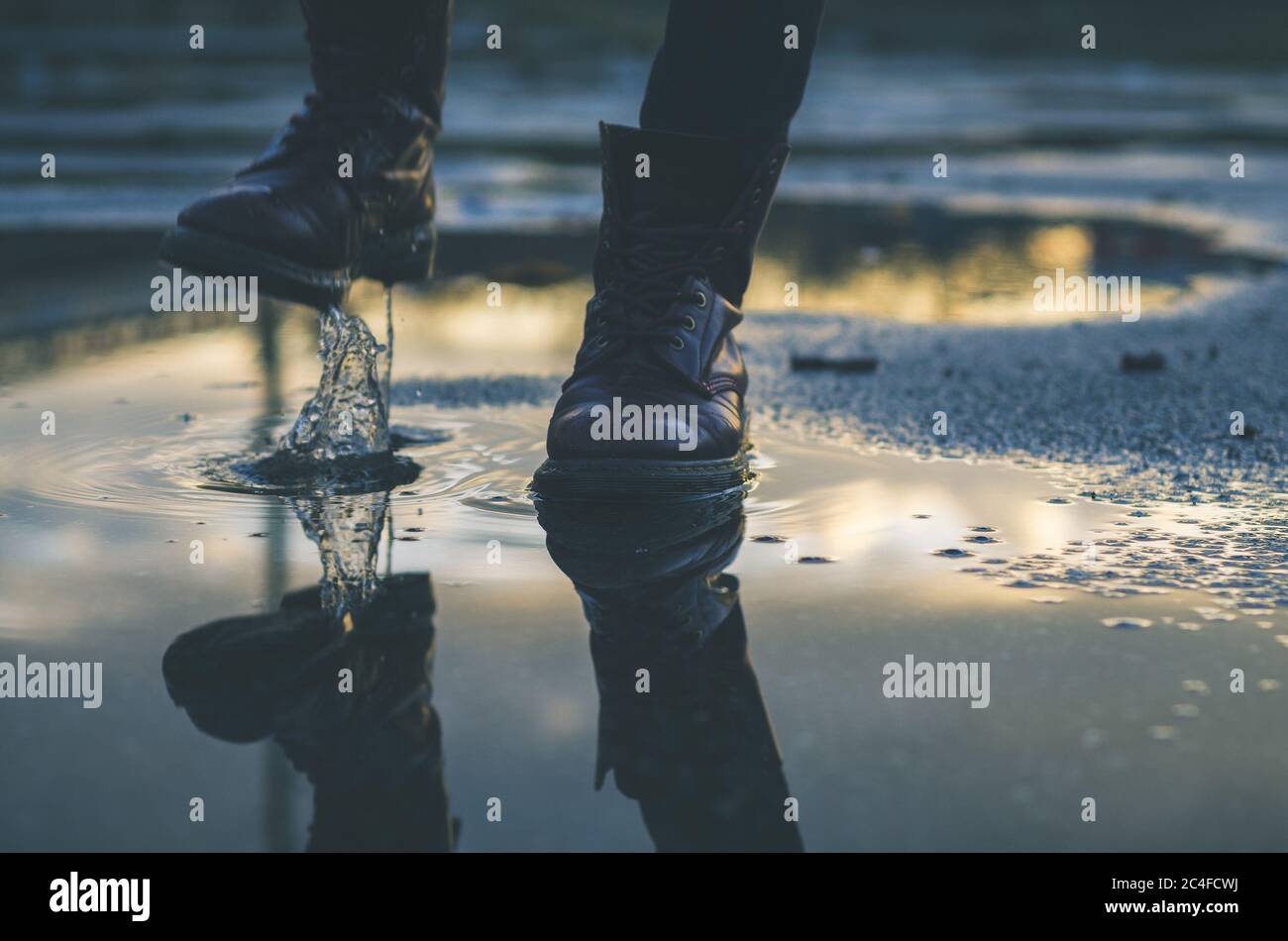 Woman stepping in puddle hi-res stock photography and images - Alamy