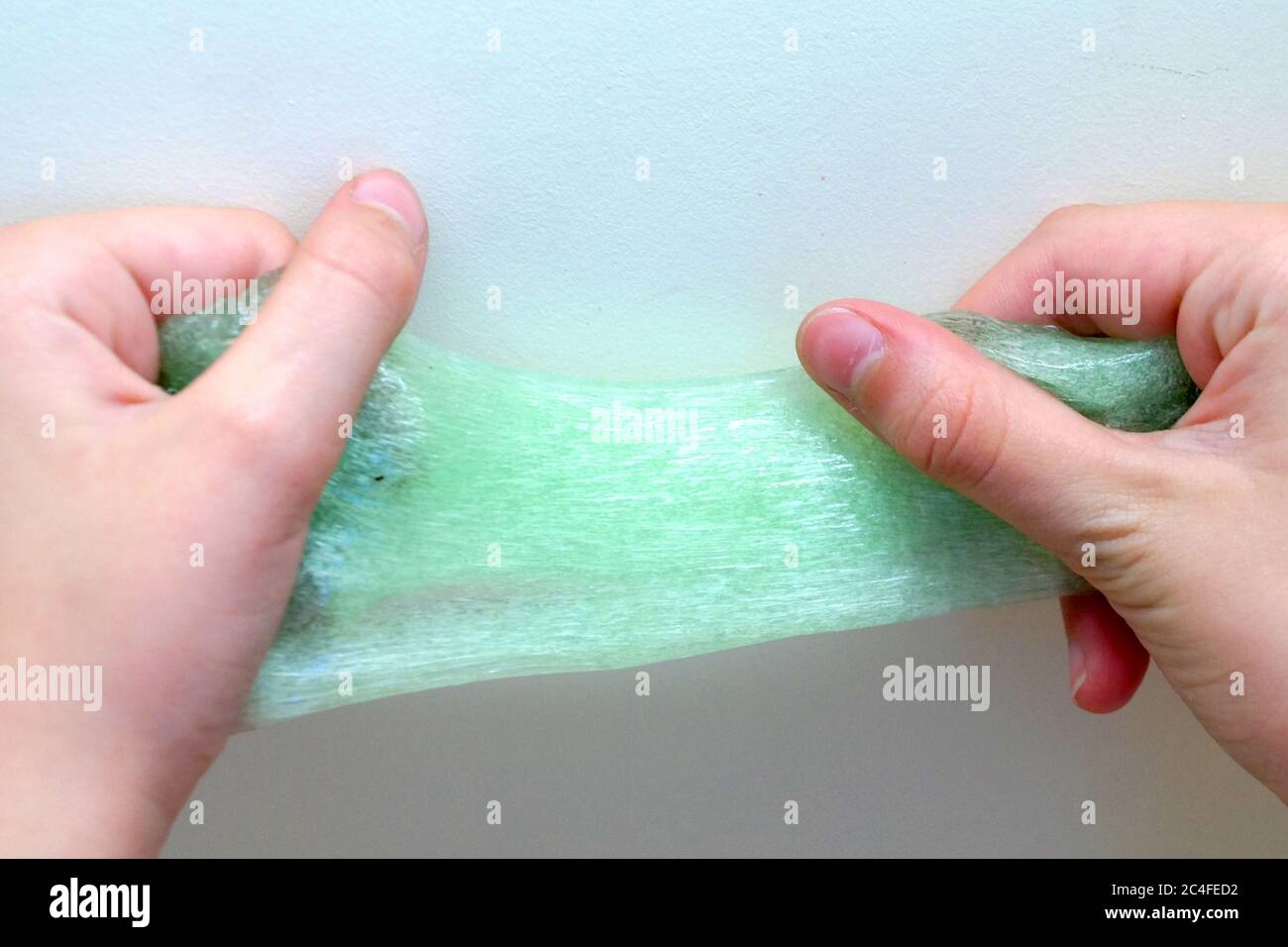 close-up of children's hands stretching green slime Stock Photo - Alamy