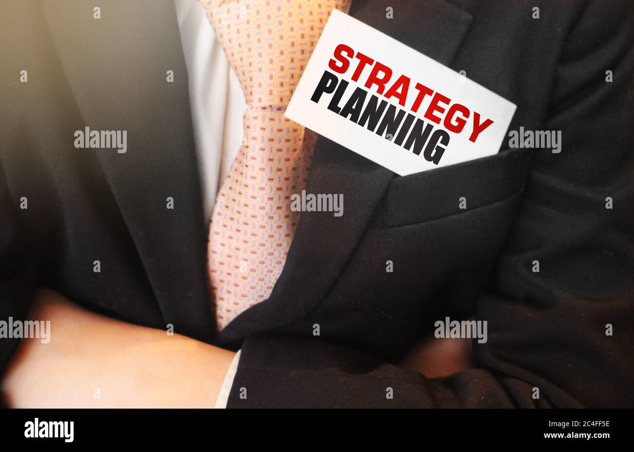 Businessman put card with text Strategy planning in pocket. Business ...