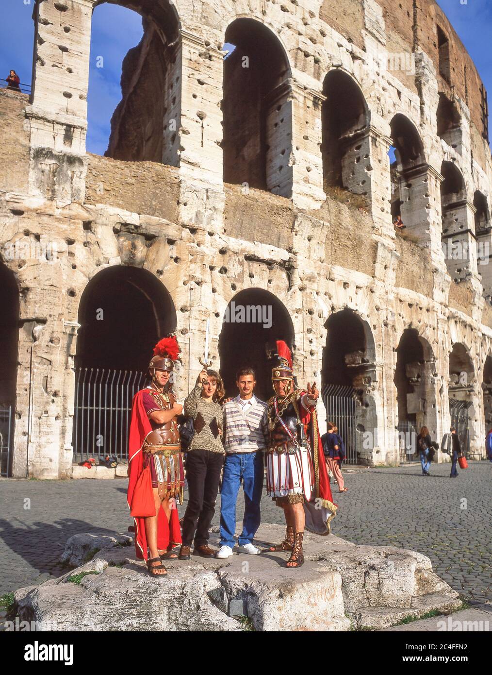 Roman soldier buskers posing with tourist couple in front of The ...