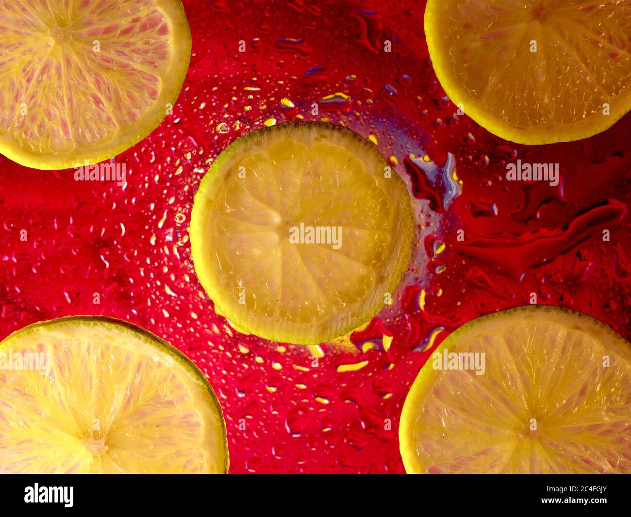 Sliced Lime on a background of solid colour with water droplets Stock ...
