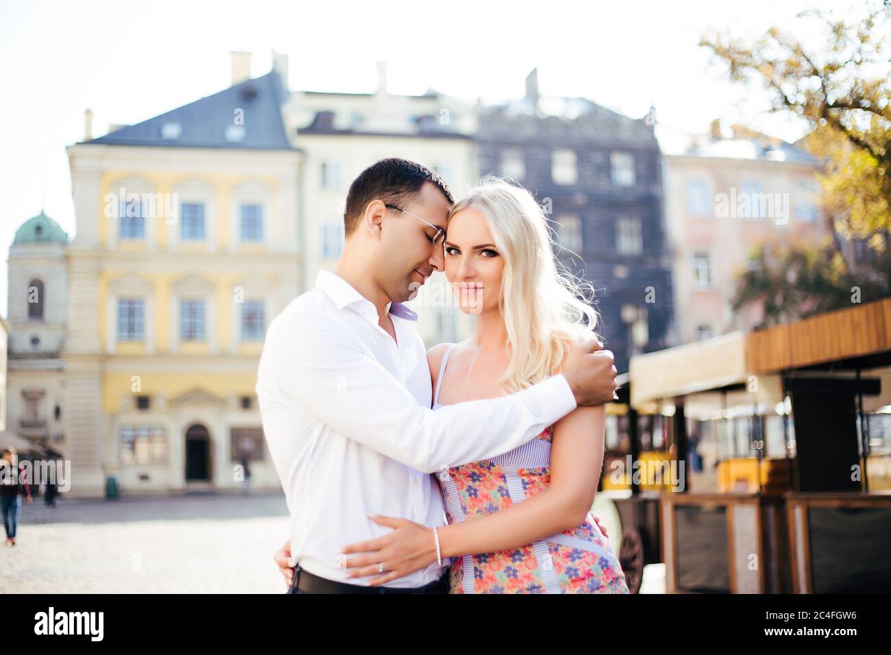 Young couple in love hug each other on city background Stock Photo - Alamy
