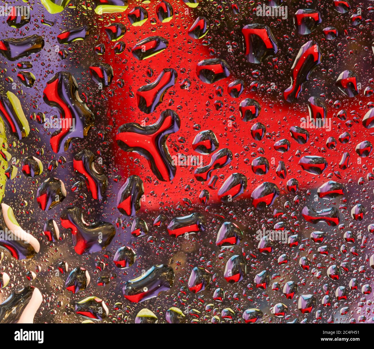 Red accent colour of water droplets on a hard surface Stock Photo - Alamy