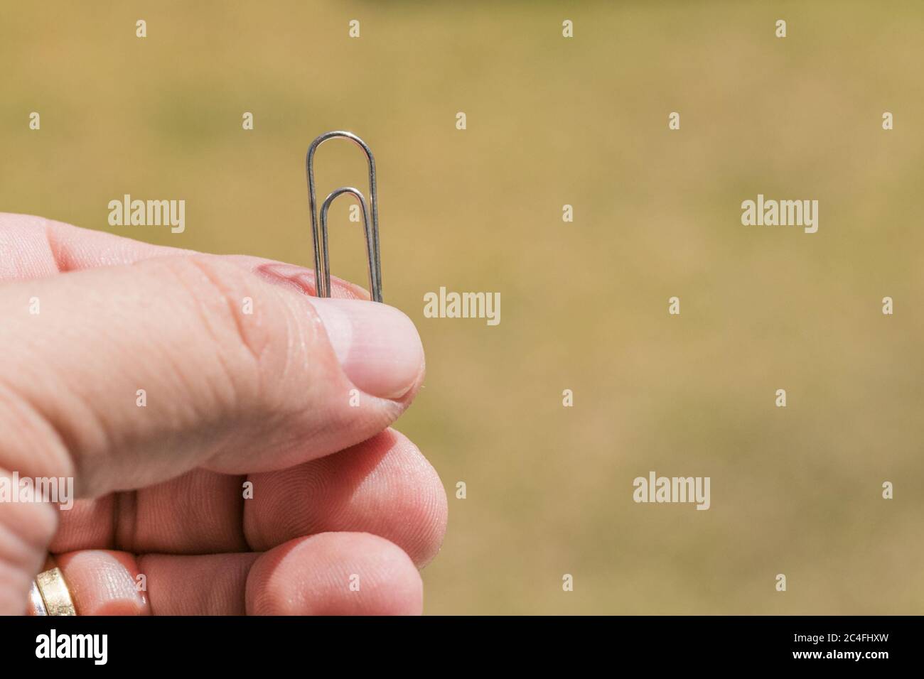 Holding a paper clip in my hand Stock Photo - Alamy