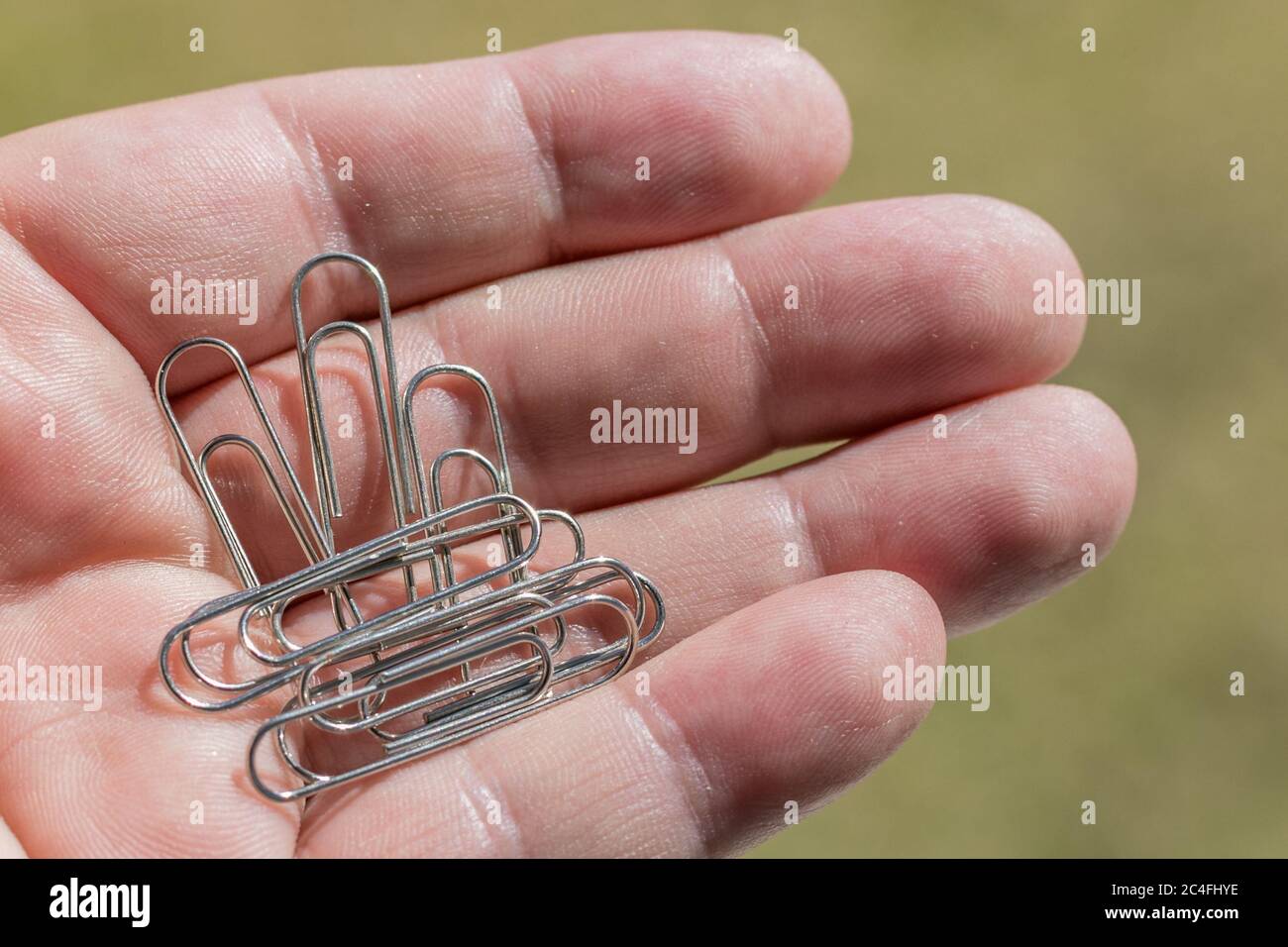 Holding a paper clip in my hand Stock Photo - Alamy