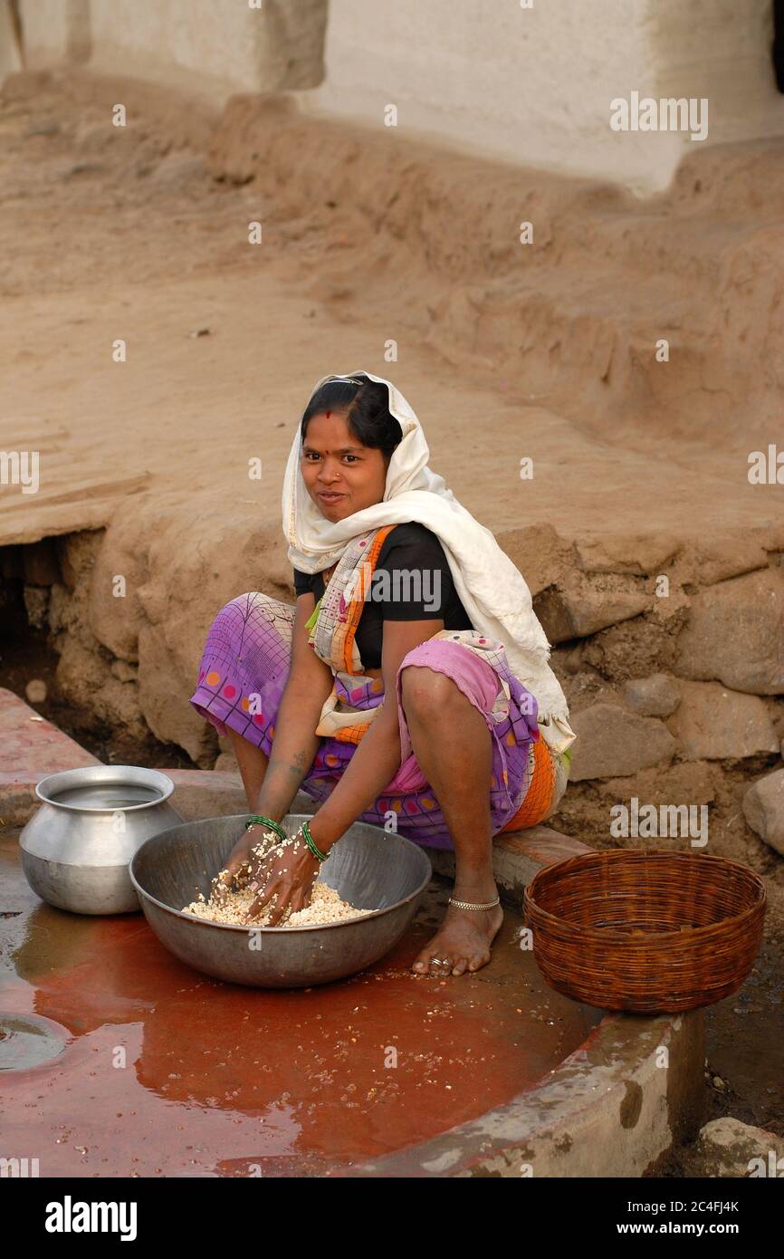 A young woman soaking and washing lentils, a common dish known locally ...