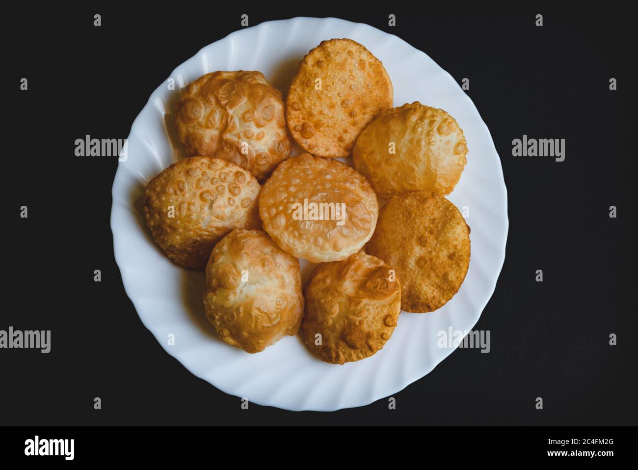 Top view of Indian puri with black background Stock Photo - Alamy