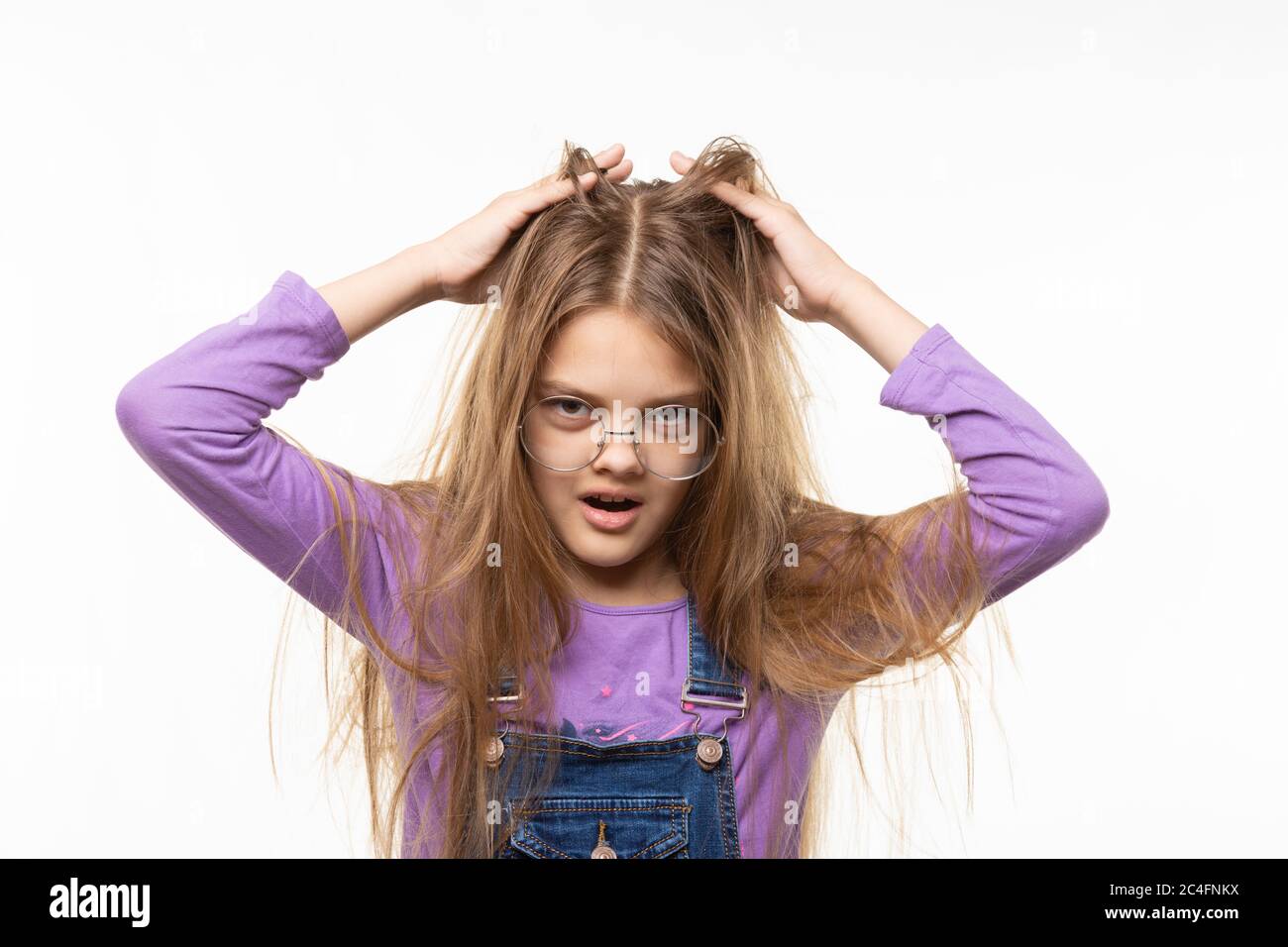 Long-haired girl scratches her head with her hands Stock Photo - Alamy