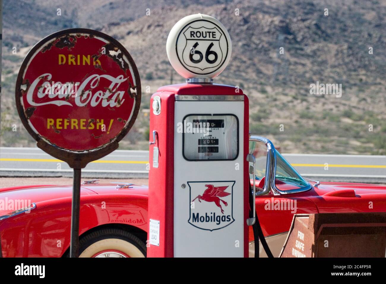 vintage red chevrolet corvette 56, on historic route 66, in front of ...