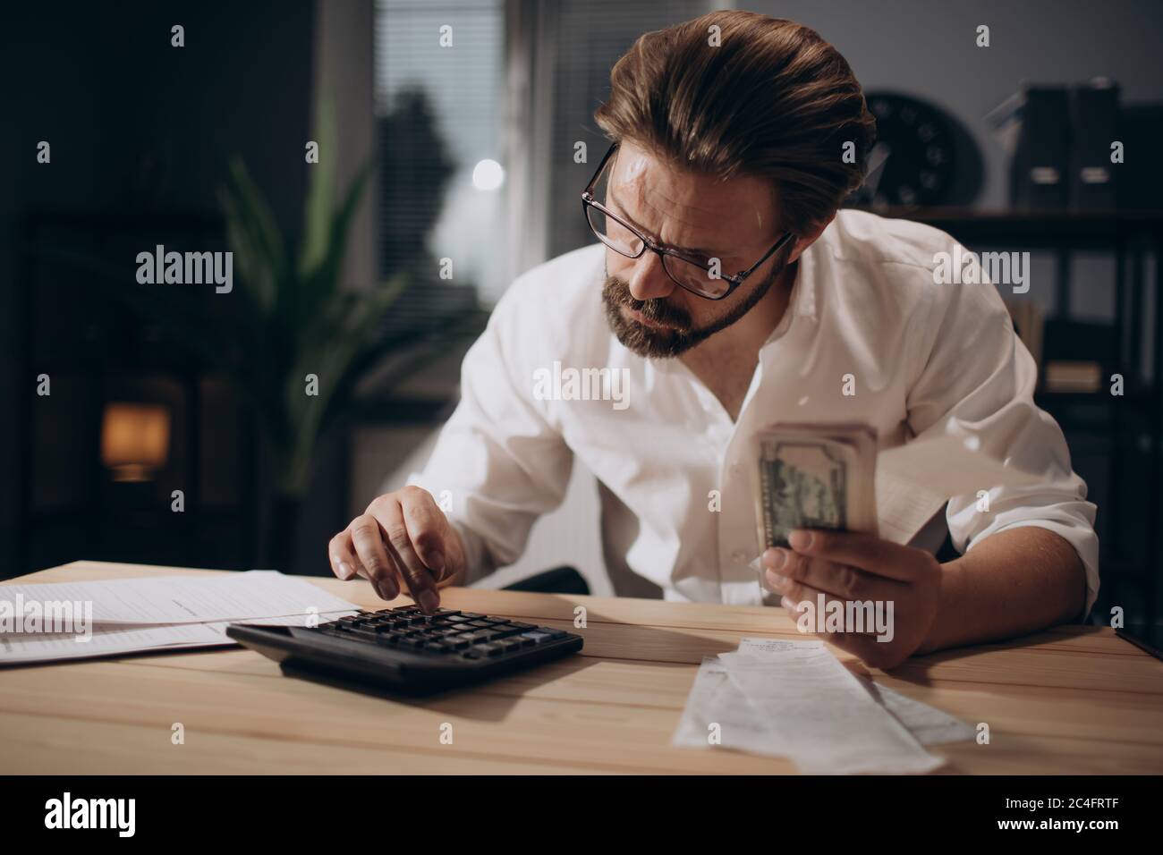 Businessman calculator checking bills hi-res stock photography and ...
