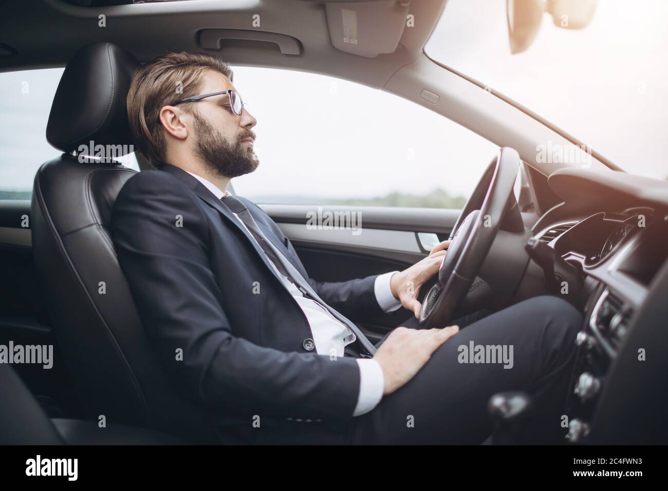 Serious bearded man in formal clothing driving car Stock Photo - Alamy