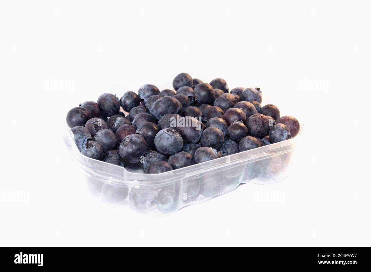 Fresh blueberries in a tub on white background Stock Photo - Alamy