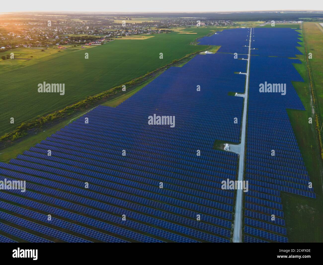 Aerial drone view of large solar panels at a solar farm at bright ...