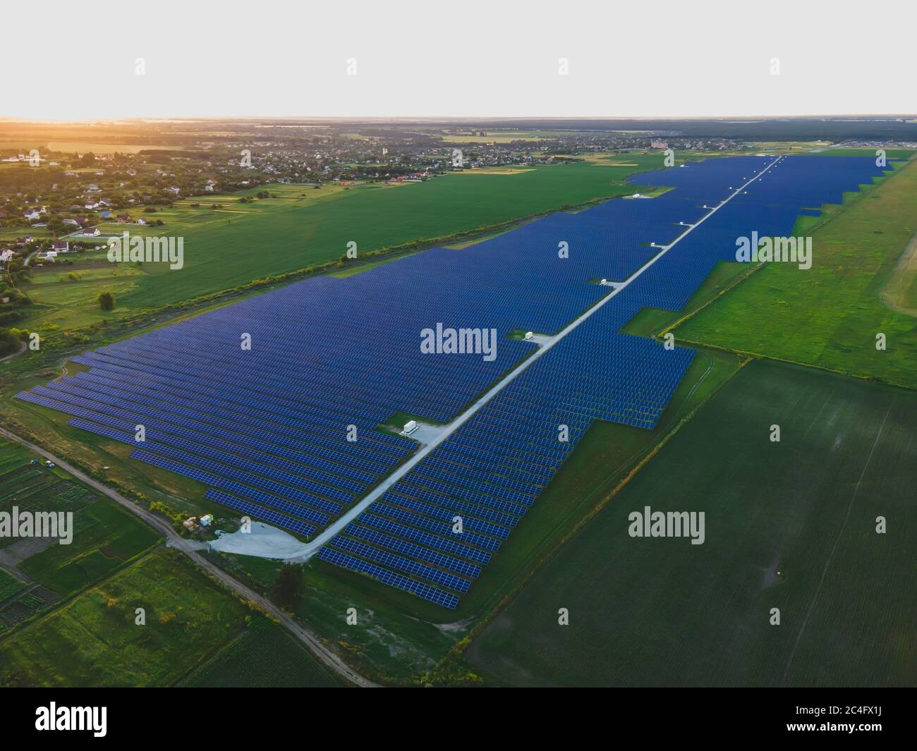 Aerial drone view of large solar panels at a solar farm at bright ...