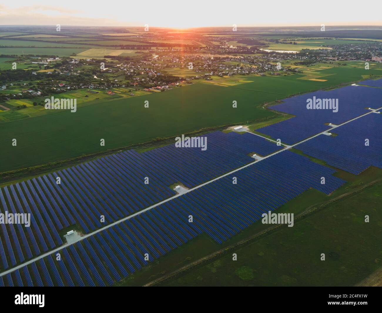 Aerial drone view of large solar panels at a solar farm at bright ...