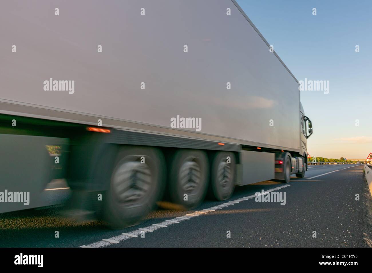 Truck with refrigerated semi-trailer moving on the highway Stock Photo ...