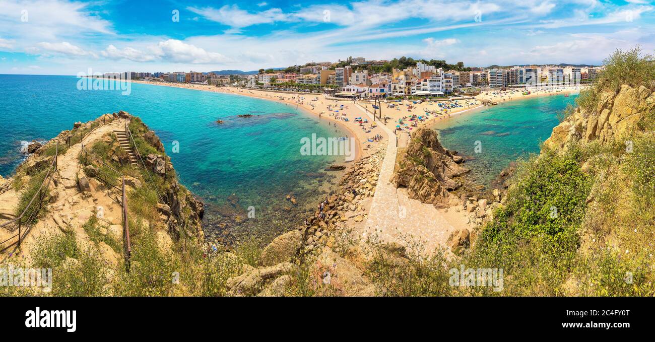 Tourists enjoy at the beach in Blanes in Costa Brava in a beautiful ...