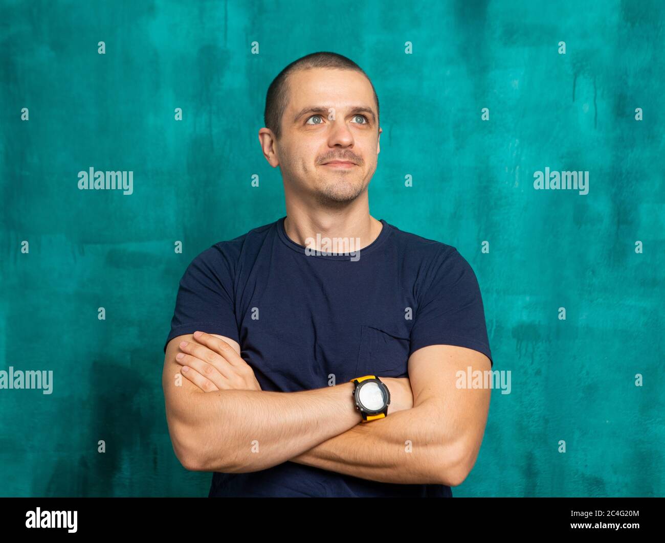 Adult handsome man with crossed hands at green backgound Stock Photo ...