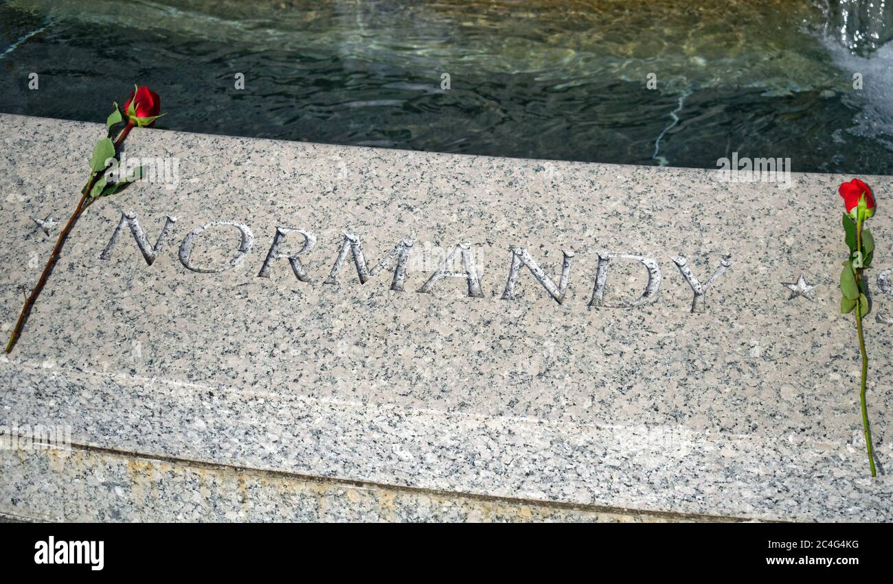 Two roses are laid down next to the inscription Normandy, dedicated to ...