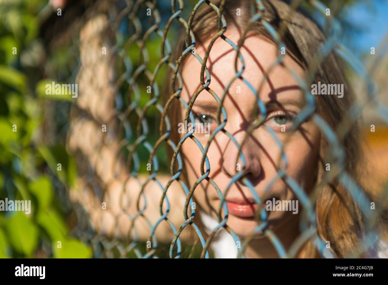 Girl posing behind fence hi-res stock photography and images - Alamy