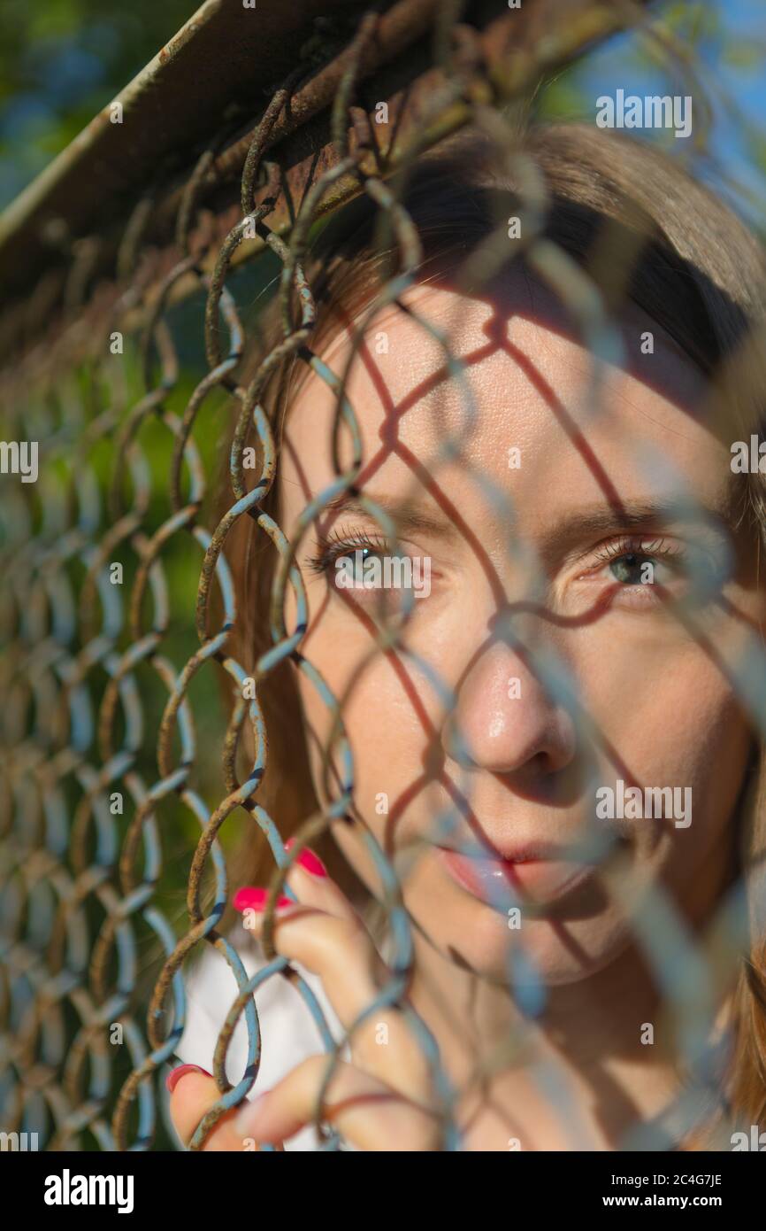 Girl posing behind fence hi-res stock photography and images - Alamy