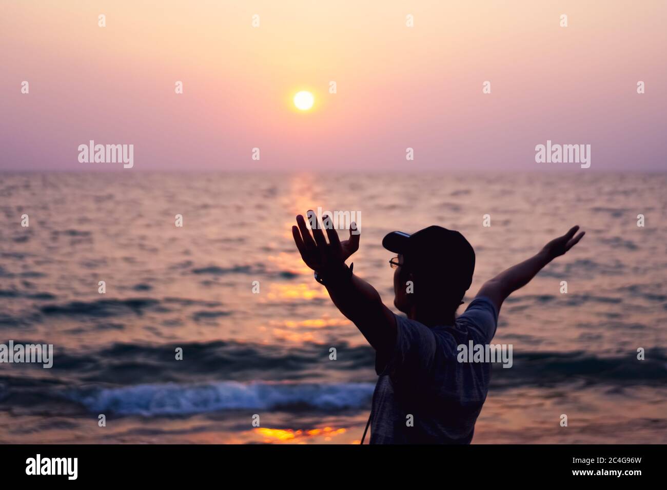 Man rise hands up to sky freedom concept with sunset sky and summer ...