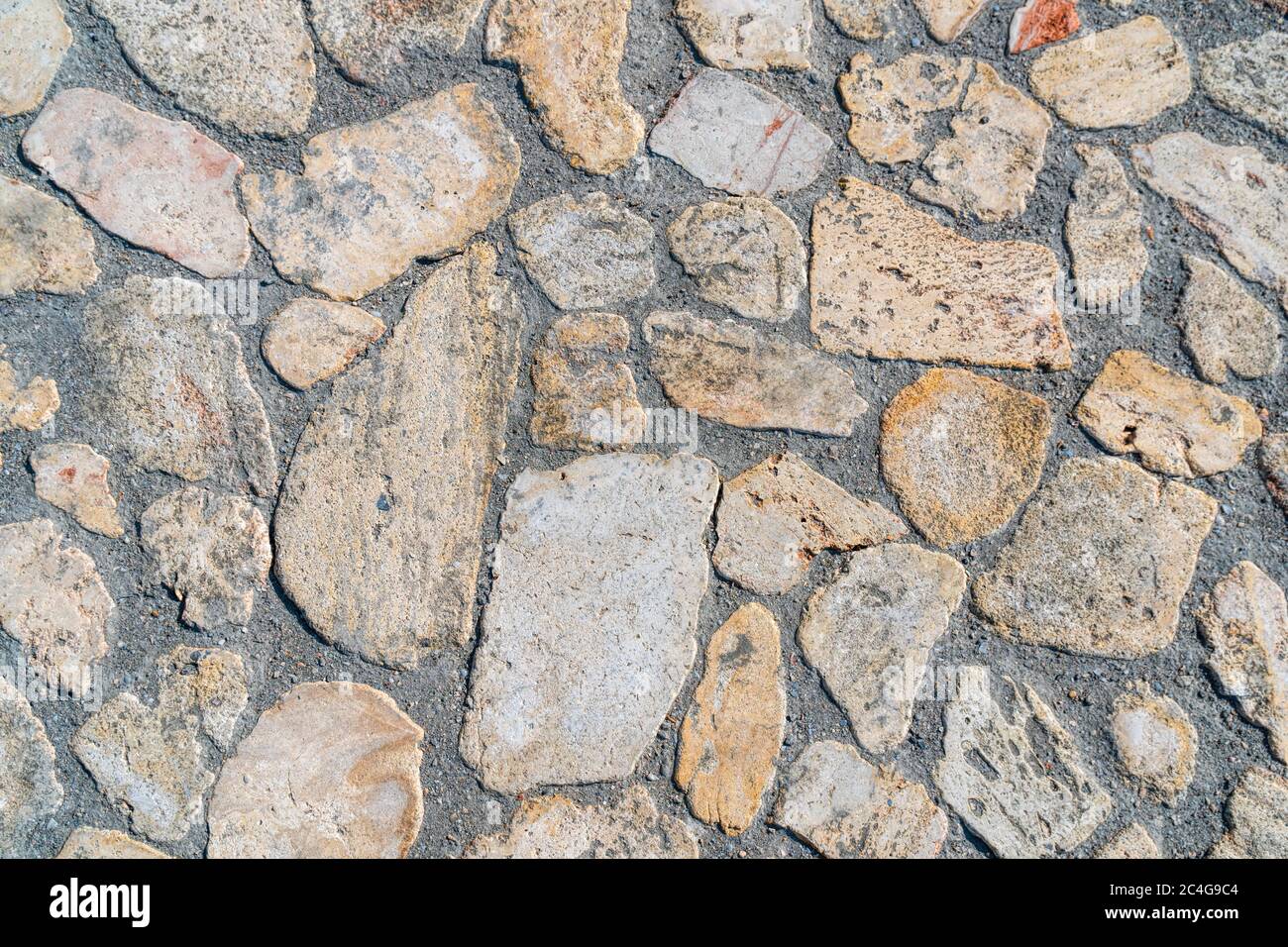 The road paved from wild paving stones of various shapes. Wild stone ...