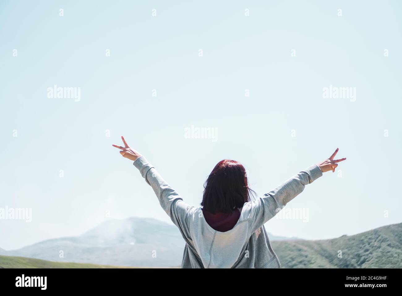 Woman rise hands up to sky freedom concept with blue sky and summer ...
