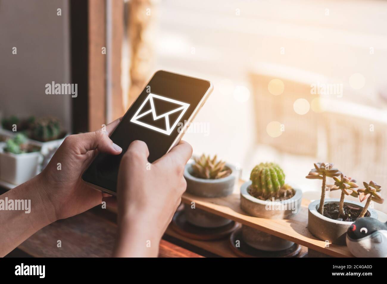 Woman hand using smartphone and it's show email recieve notification ...
