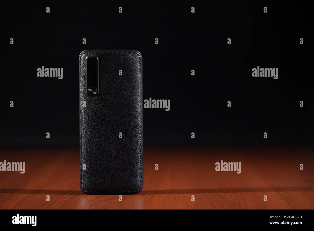 black power bank for charging mobile devices on black background Stock ...