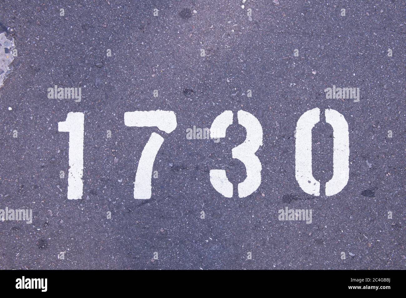Number 1650 stenciled on the asphalt in white paint Stock Photo - Alamy