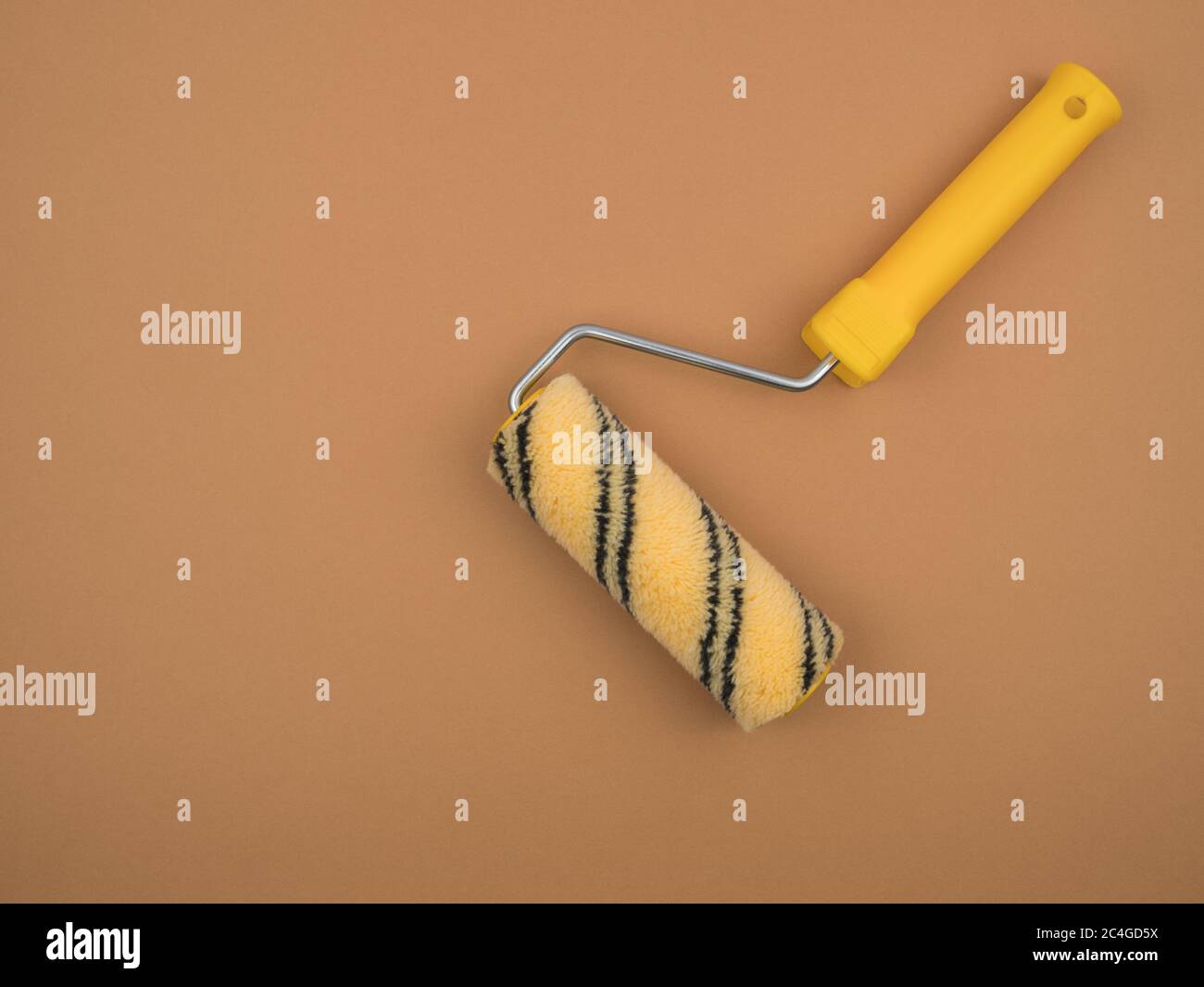 Paint roller on beige background. Construction tool Stock Photo - Alamy