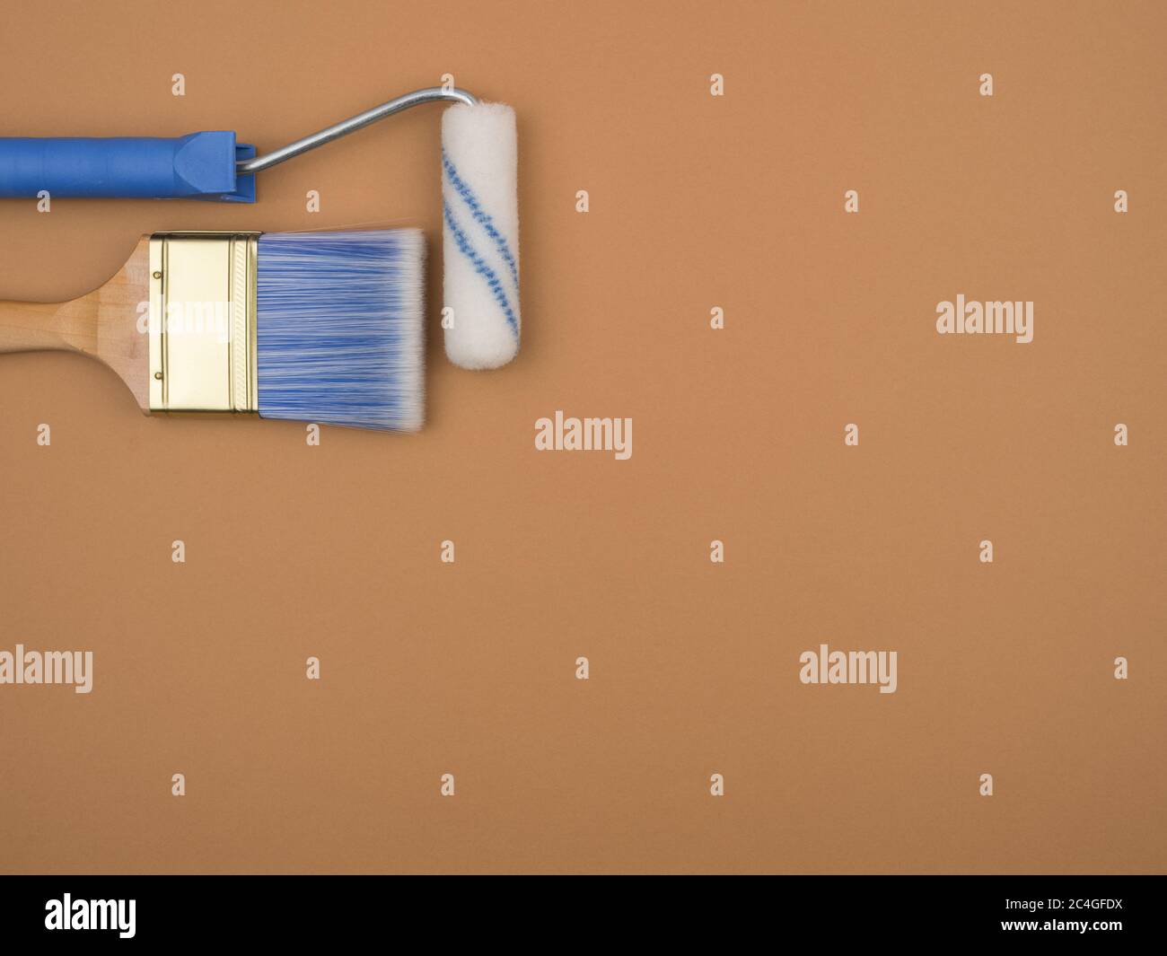 Tool for paint finishing work on beige background. The brush and roller ...
