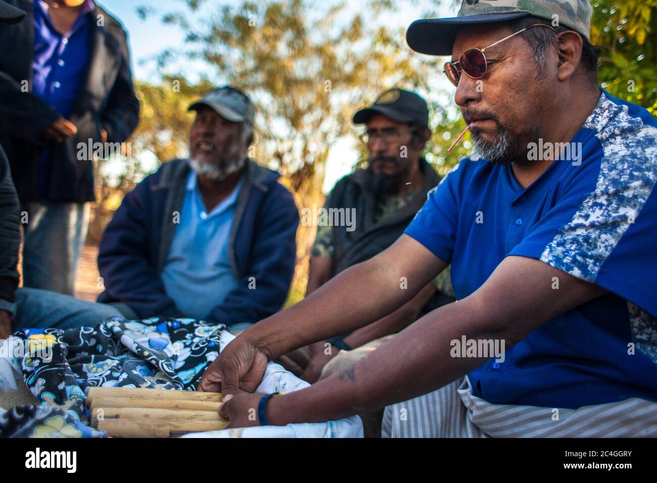 Men of the Comcáac community sit in a circle while playing a game of ...