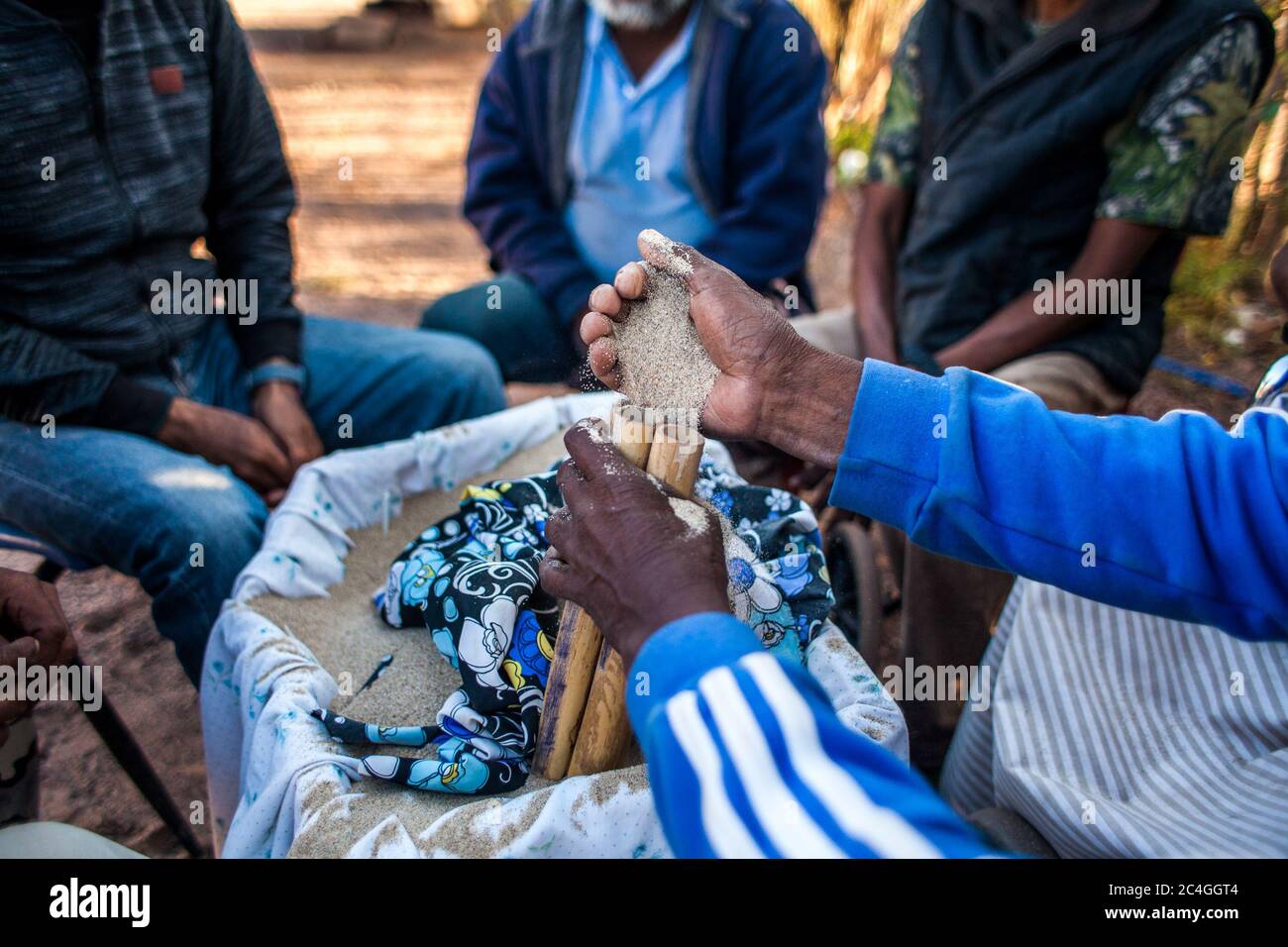 Men of the Comcáac community sit in a circle while playing a game of ...
